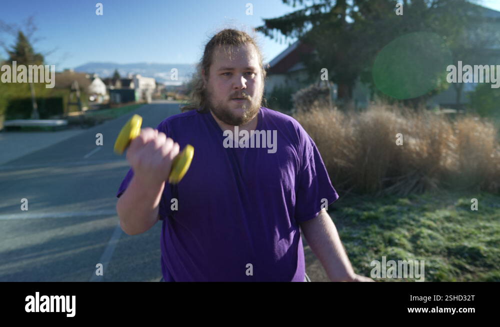 A young fat man getting back into shape building strength. Motivational ...