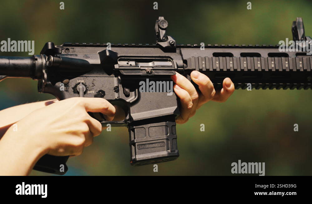 Closeup of a gun carbine during shooting, ejecting empty bullet casings ...