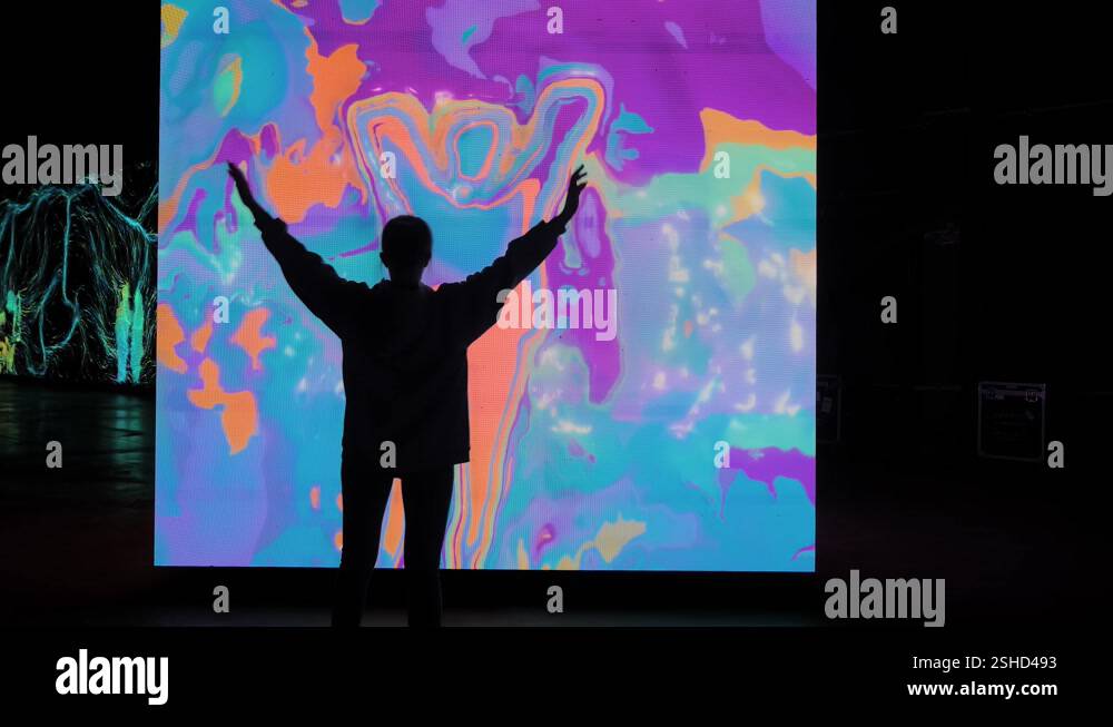 Woman moving against AR display with mirror effect at immersive event ...