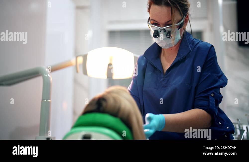 Woman sitting on dental chair, conversation with dentist. Dental clinic ...