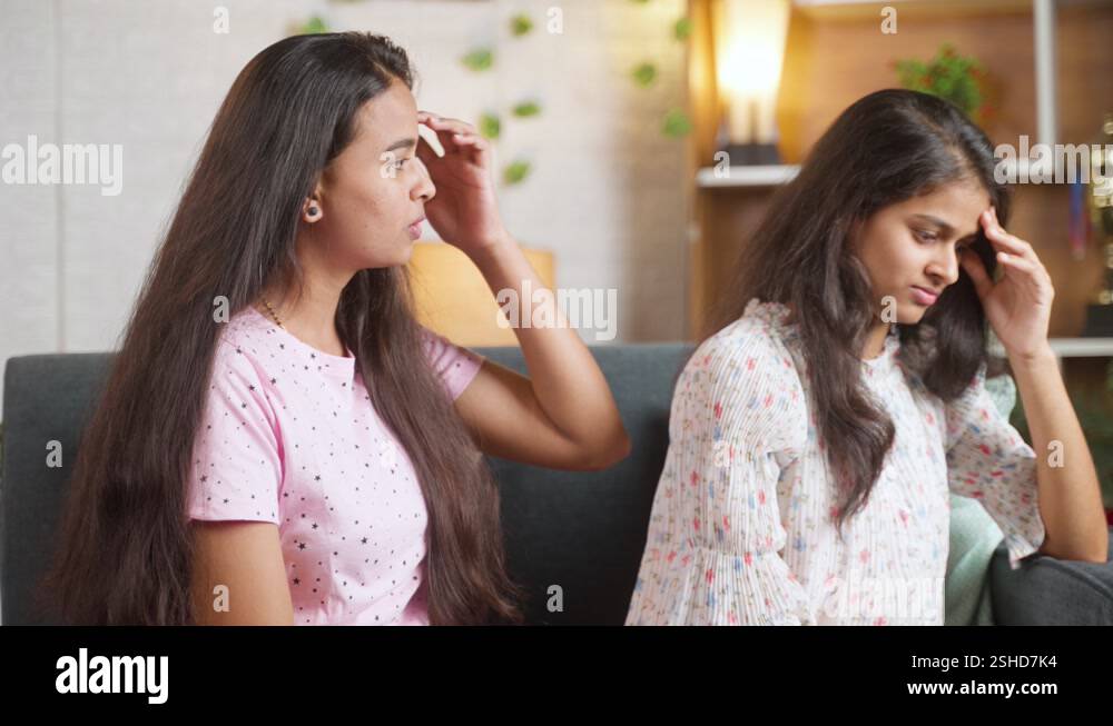 Girl consling her sad crying sibling sister at home - concept of ...