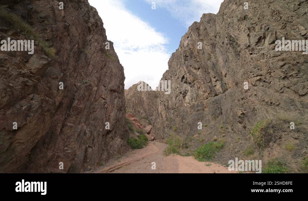 Charyn Canyon Kazakhstan arid ravine with flora and jagged rocks ...