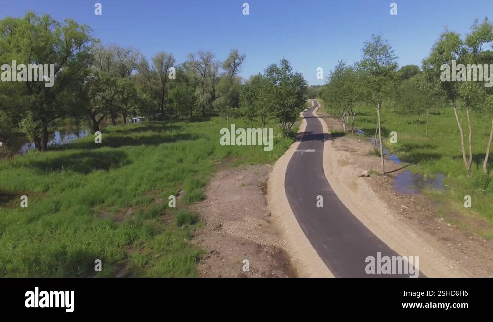 Walking Path Winds Through Wetlands in the Park. Aerial Tracking Shot ...