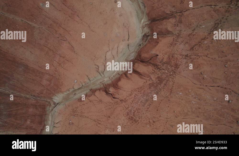 Dry ravine snakes through red hot mars like landscape, Altyn Emel ...