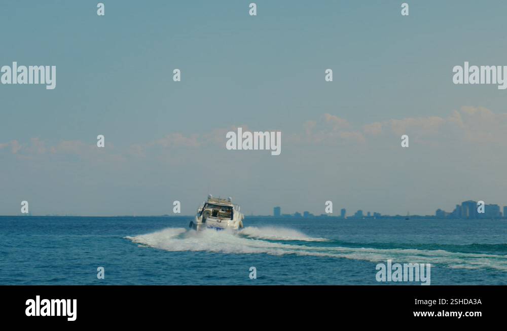 Speed boat with American flag on the back takes sharp turn in deep blue ...