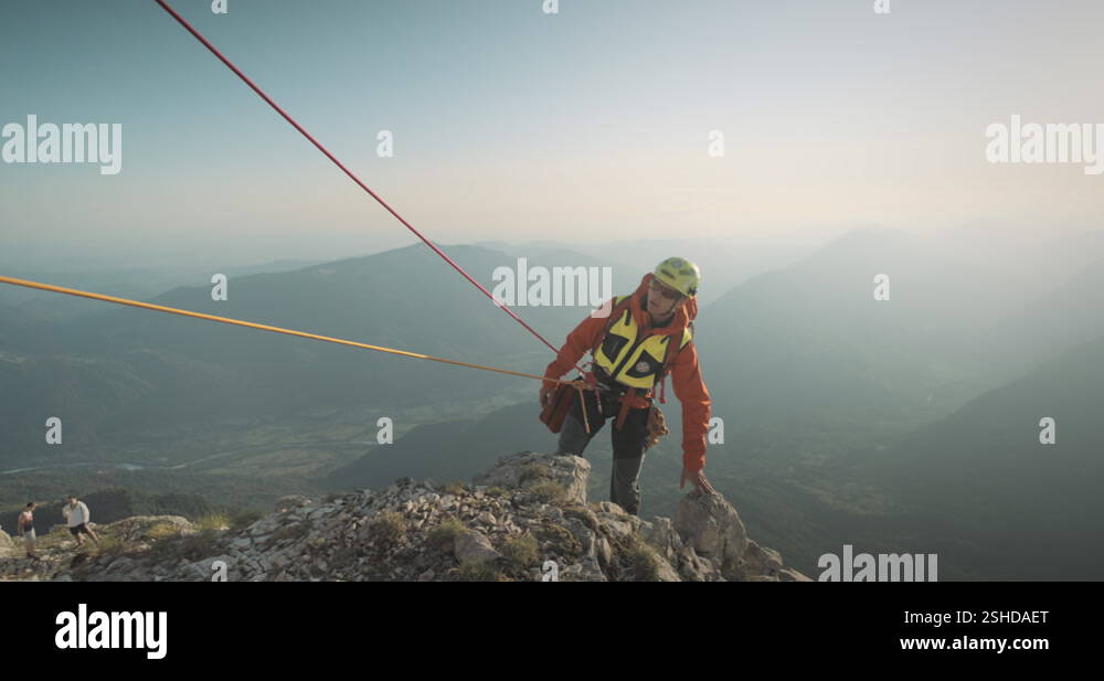 Hiker descendig fron the rock downwards with small steps backwards ...