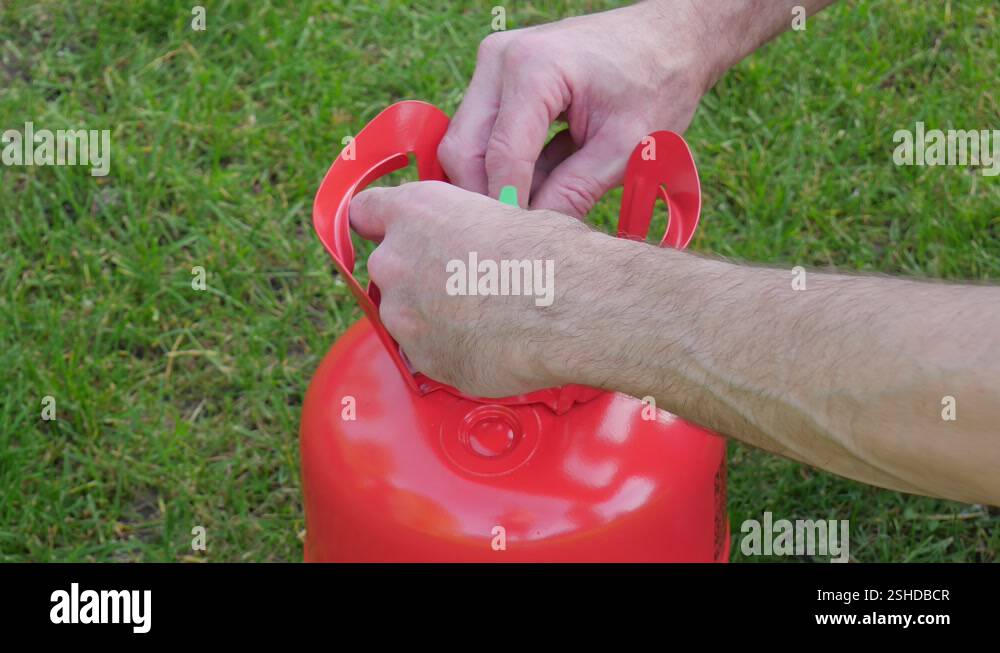 Balon for inflating balloons for a holiday, birthday. A man inflates a ...