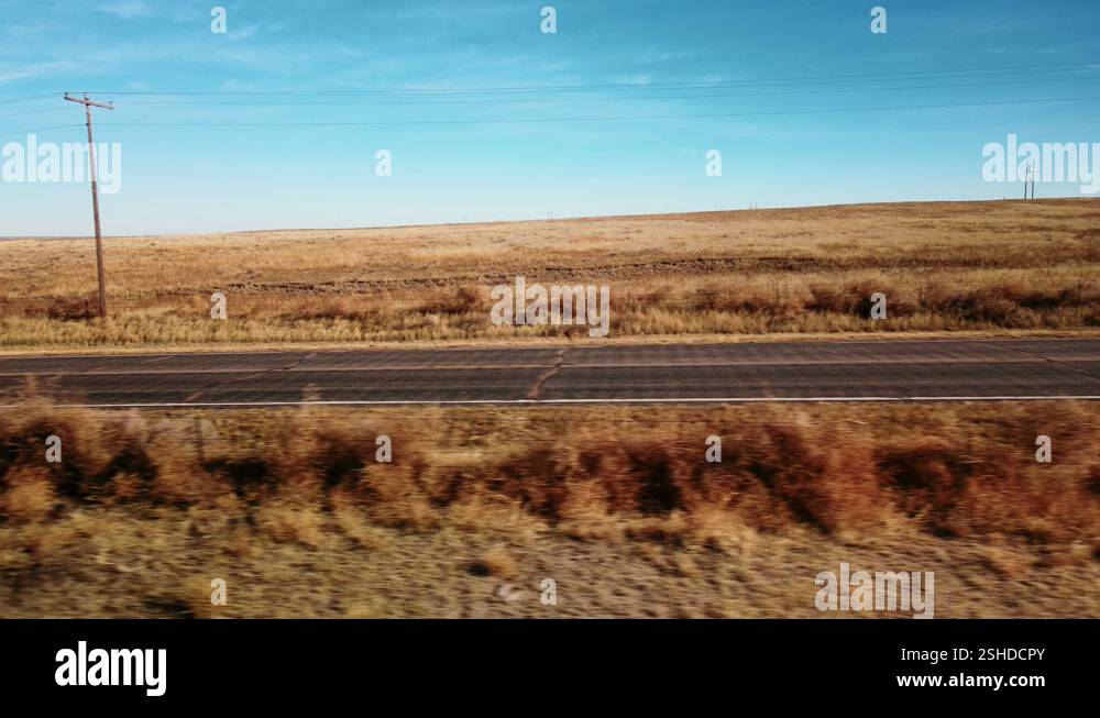 Black all-terrain car driving on a highway in a dry and desert ...