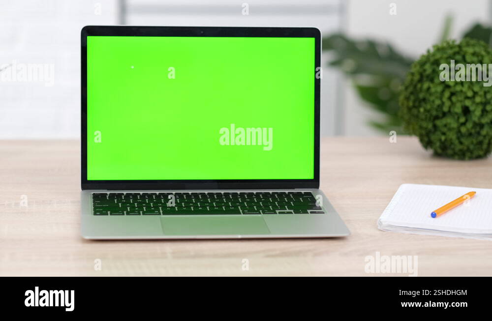 laptop notebook computer with green screen chroma key on work table ...