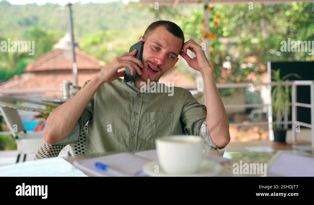 a young guy talking cheerfully and enthusiastically on the phone Stock ...