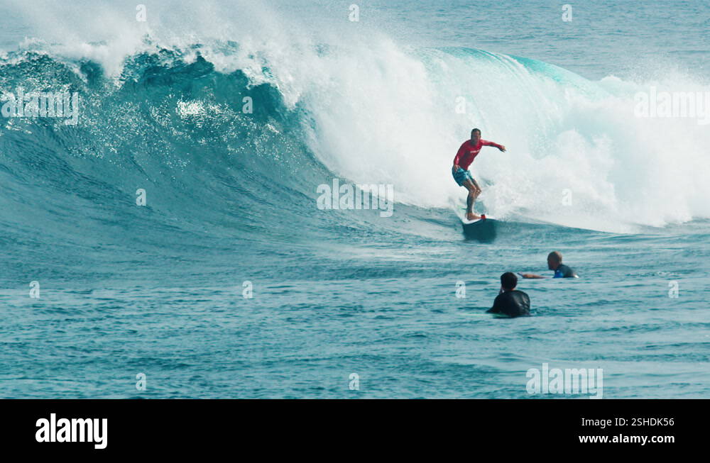Surfer surfs the wave. Male surfer rides the wave in the Maldives Stock ...