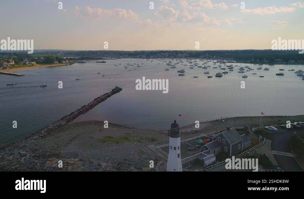Massachusetts Lighthouse with an American flag, Harbor with lots of ...