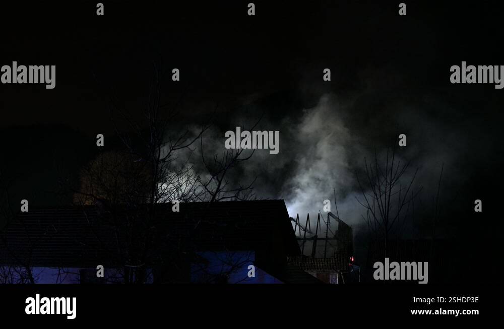 A house in the countryside is on fire while firefighters put it out at ...