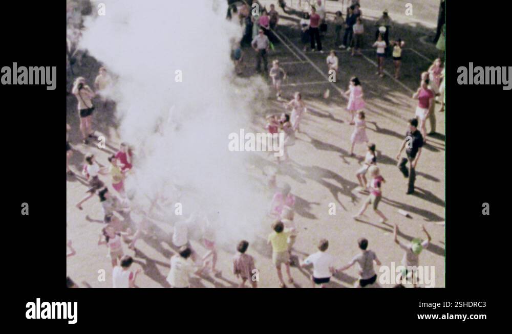1970s: Man pours grapes into barrel. Fireworks explode, kids running in ...