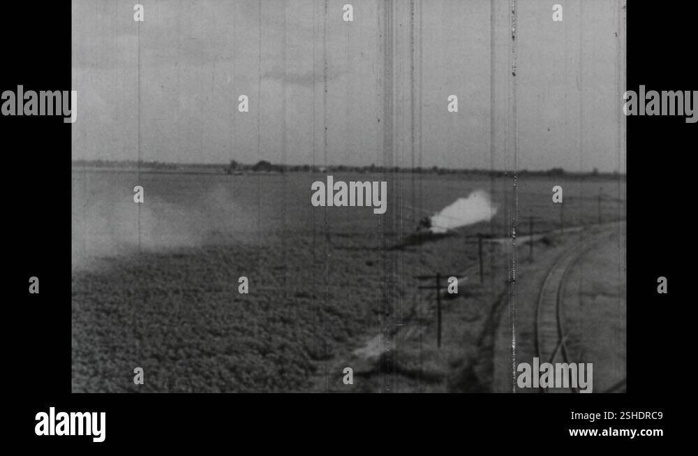 1940s: Crop duster plane dusts insecticide over fields of cotton ...
