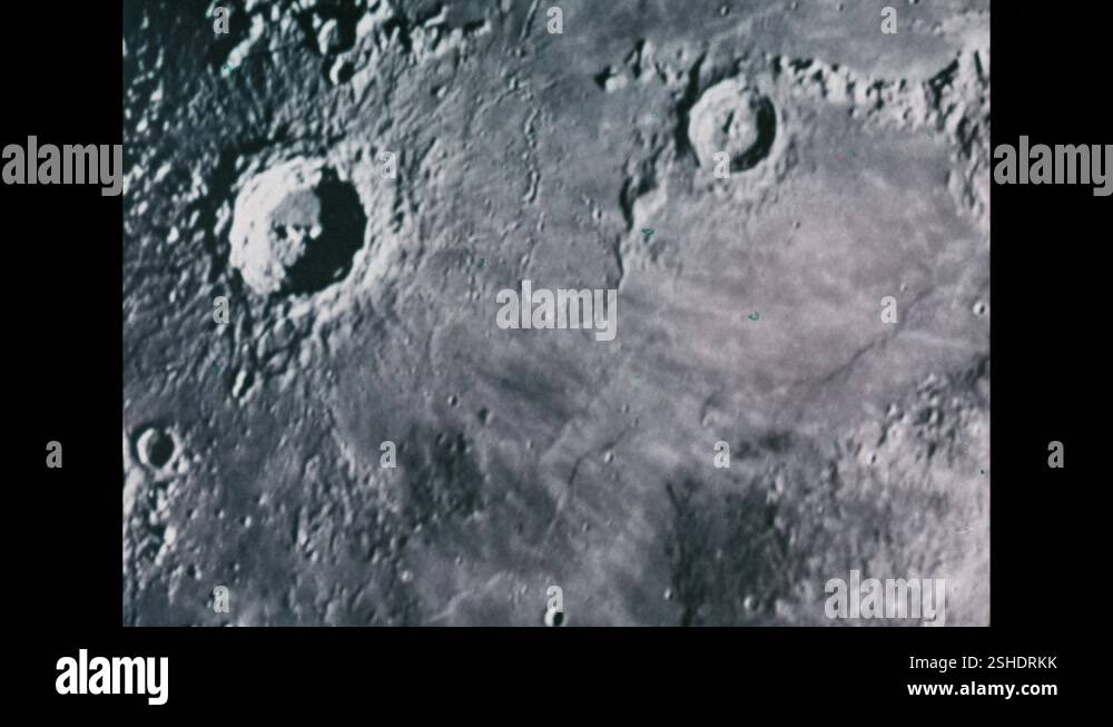 1960s:Telescope view of the moon. Craters on the moon. People look ...