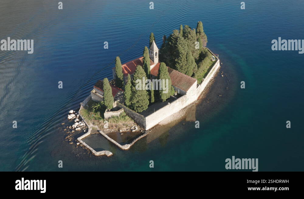 Small green island with stone church - an islet isolated against deep ...