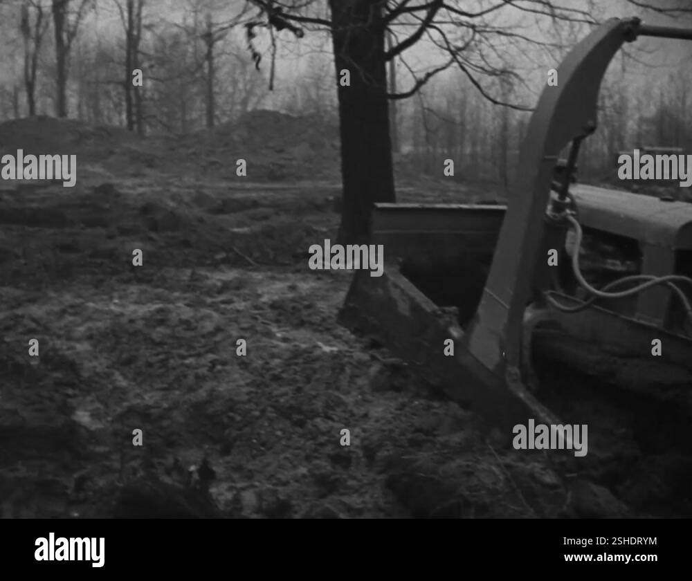 1940s: Crane lifts stuck bulldozer from mud Stock Video Footage - Alamy