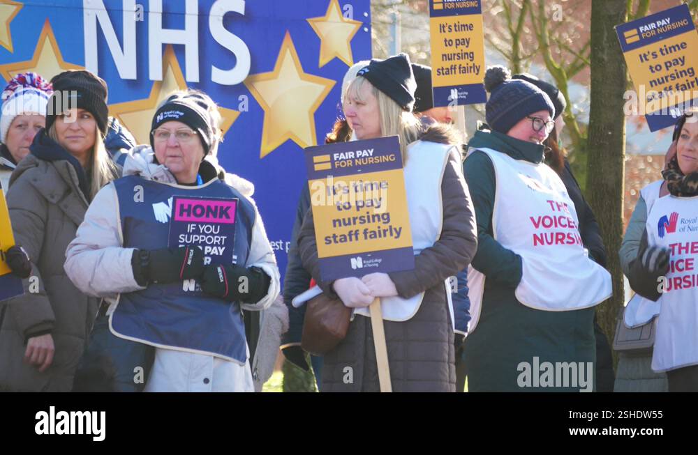 NHS nurses strike for fair pay, waving banners and flags outside UK St ...