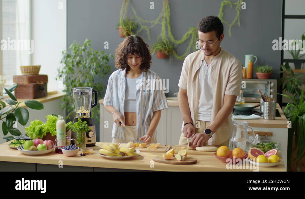 Couple Cutting Fruit and Telling Smoothie Recipe on Camera Stock Video ...