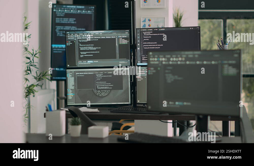 Computer screens on desk in empty data room displaying program code and Stock Video Footage - Alamy