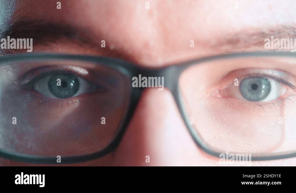 Closeup macro human eyes open. Man face glasses slow motion blue eyes ...