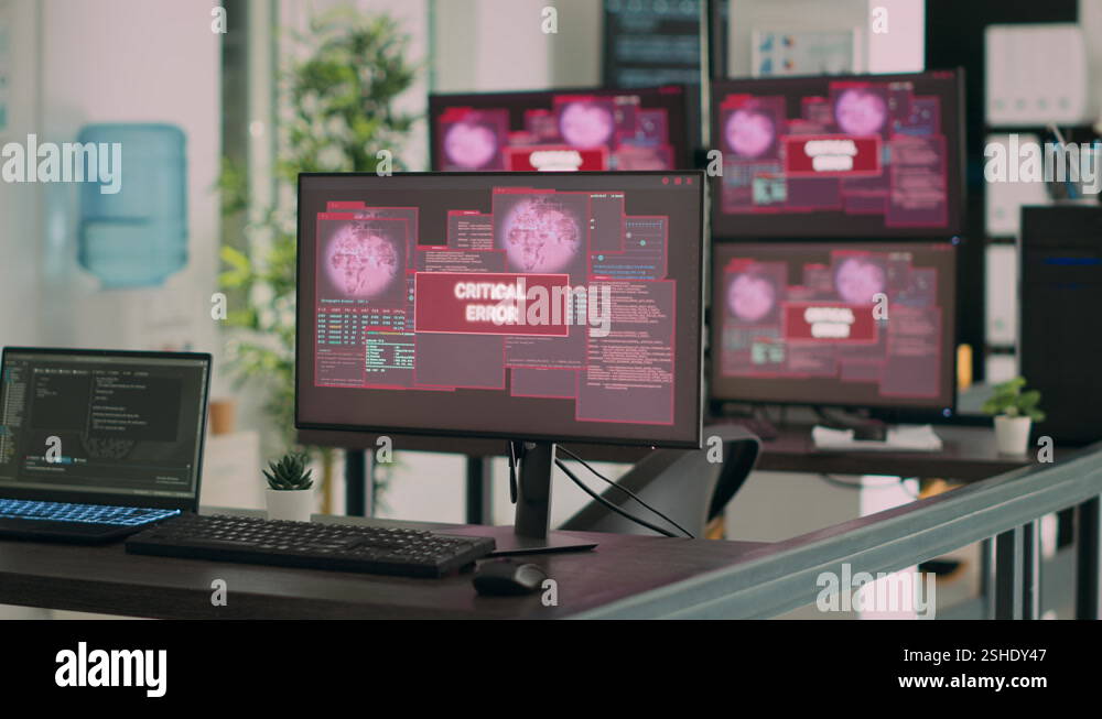 Empty it office desk with multiple computers showing security breach ...