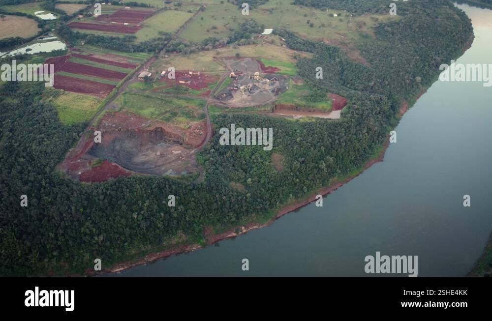Open stone quarry in Brazil along thw Iguazu river. Aerial top-down ...