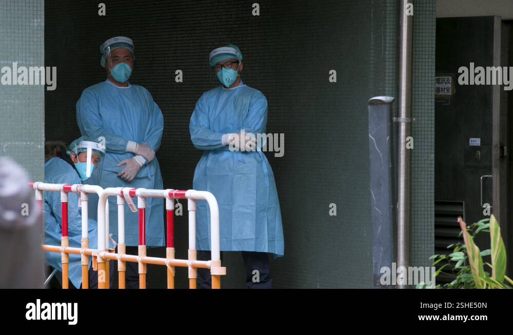 Chinese health workers dressed in PPE suits are seen inside an area ...