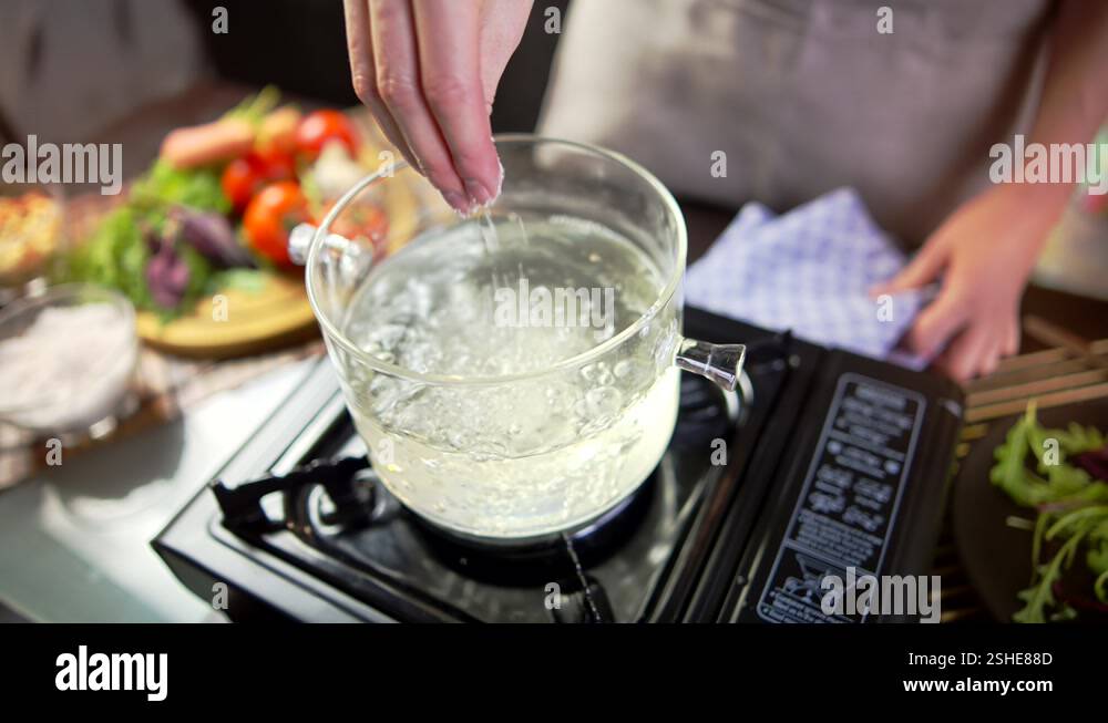 Chef Salting Food In Kitchen. Boiling Water In Pot. Chef Adds Salt Dish ...