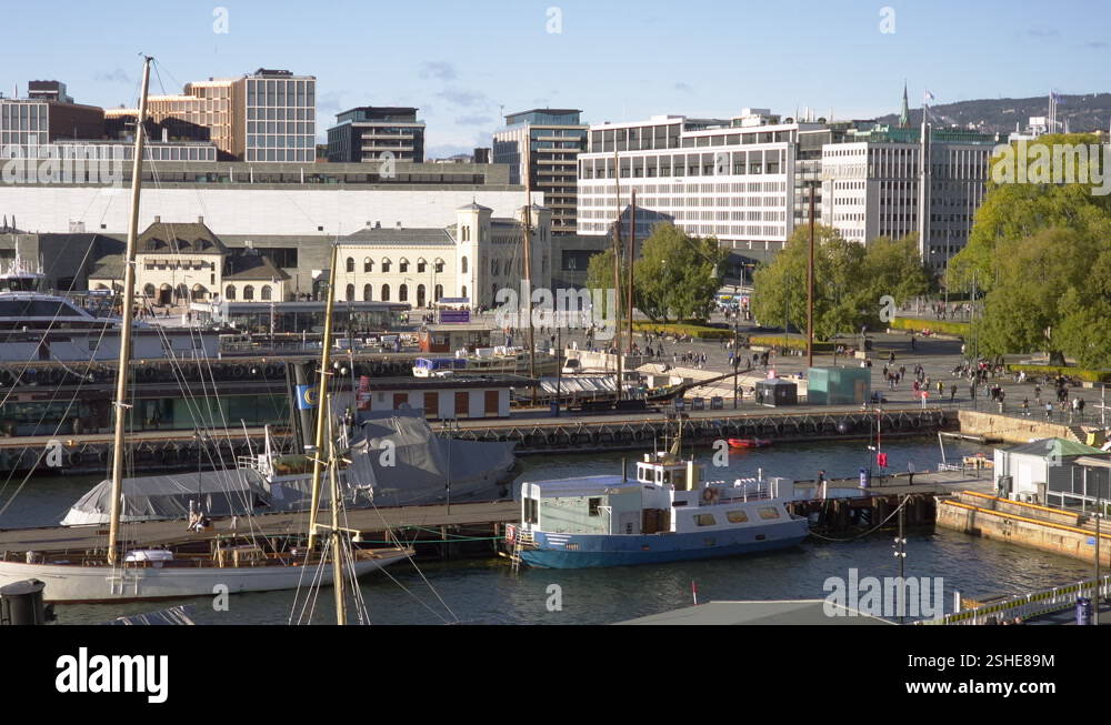 Oslo Norway cityscape, featuring boats and ferries in sea port and Aker ...
