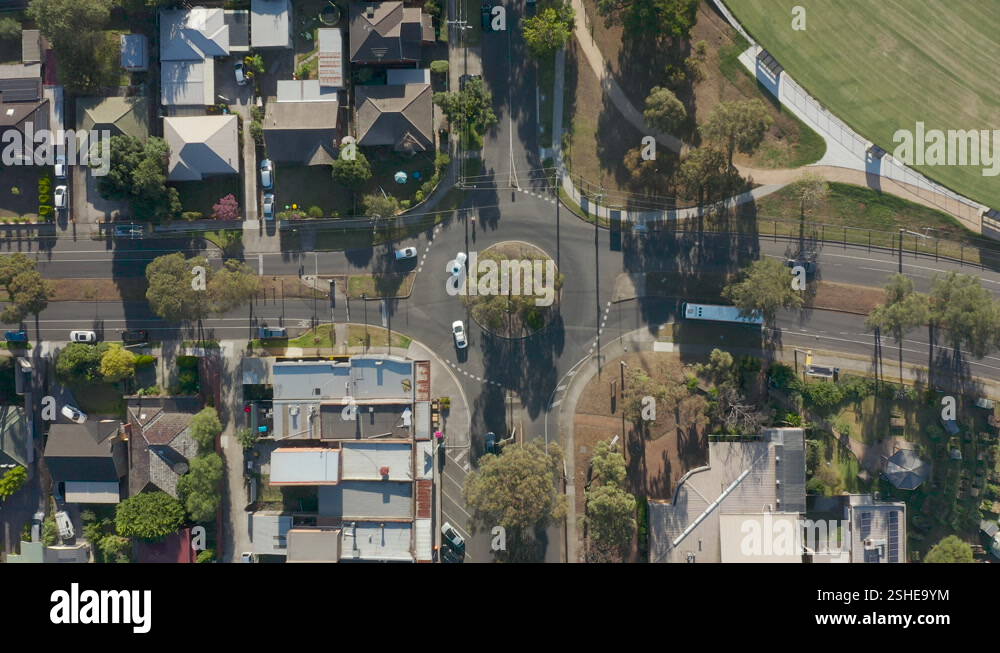 Public traffic such as cars and buses move through the neighborhood ...