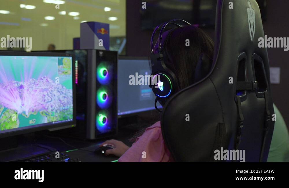 Over the shoulder of a girl pc gaming, headset gamer Stock Video ...