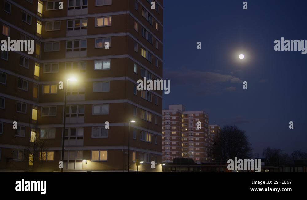 London tower block against the backdrop of the night sky with moon ...