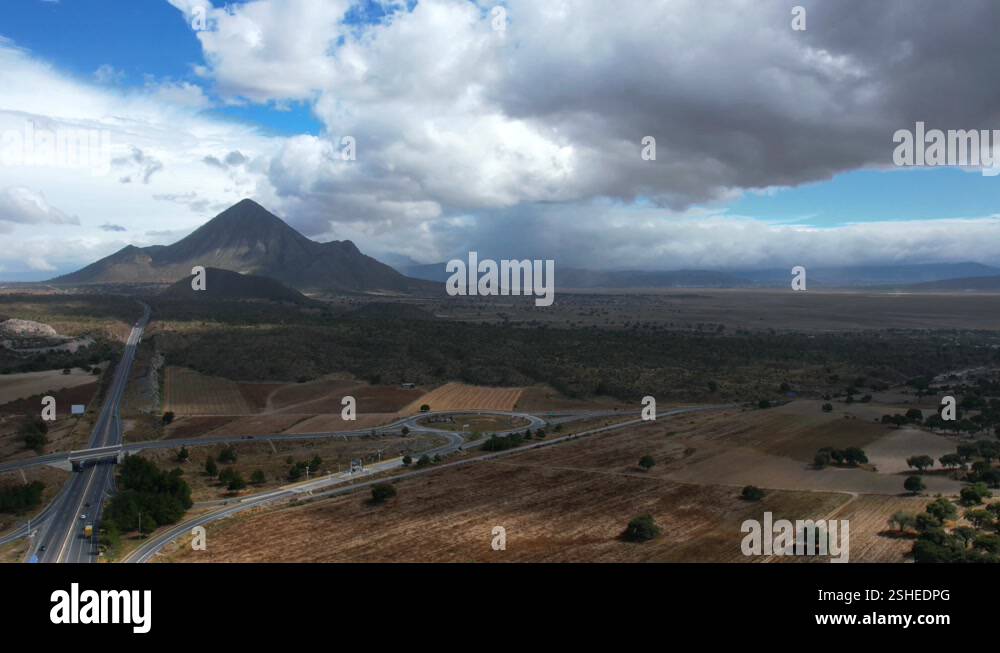 Timelapse of a Mountain and a roundabout in a mexican highway in the ...