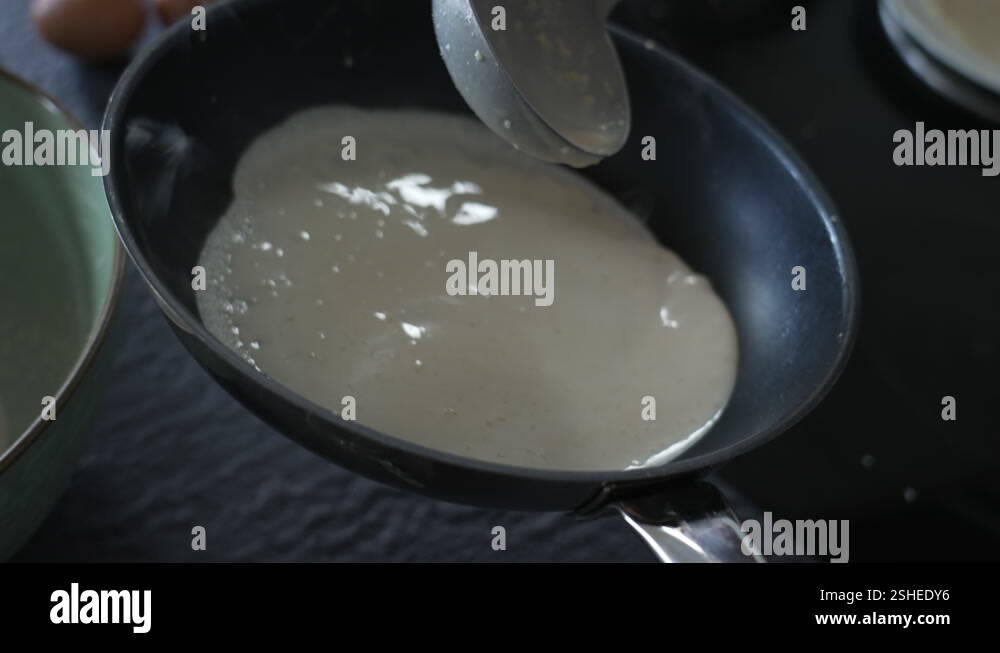 Making homemade pancakes. Cooking pancake cream into pan Stock Video ...