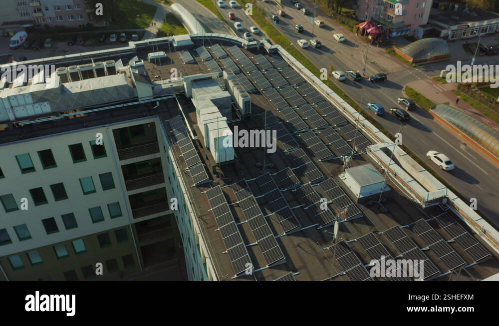 Solar panels installed on the flat roof of a multi-storey shopping mall ...