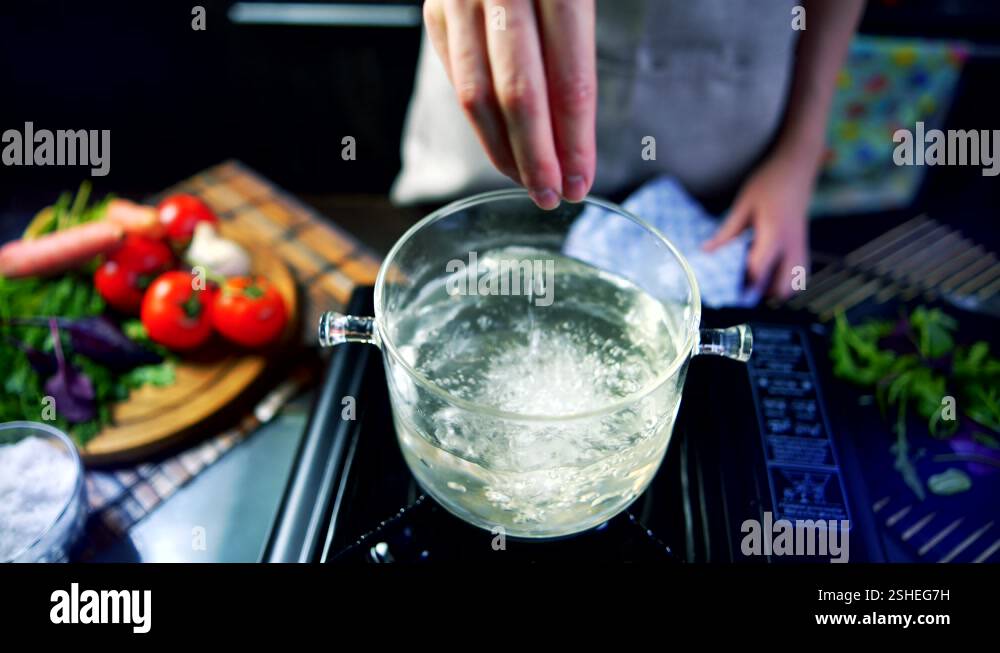 Chef Salting Food In Kitchen. Boiling Water In Pot. Chef Adds Salt Dish ...