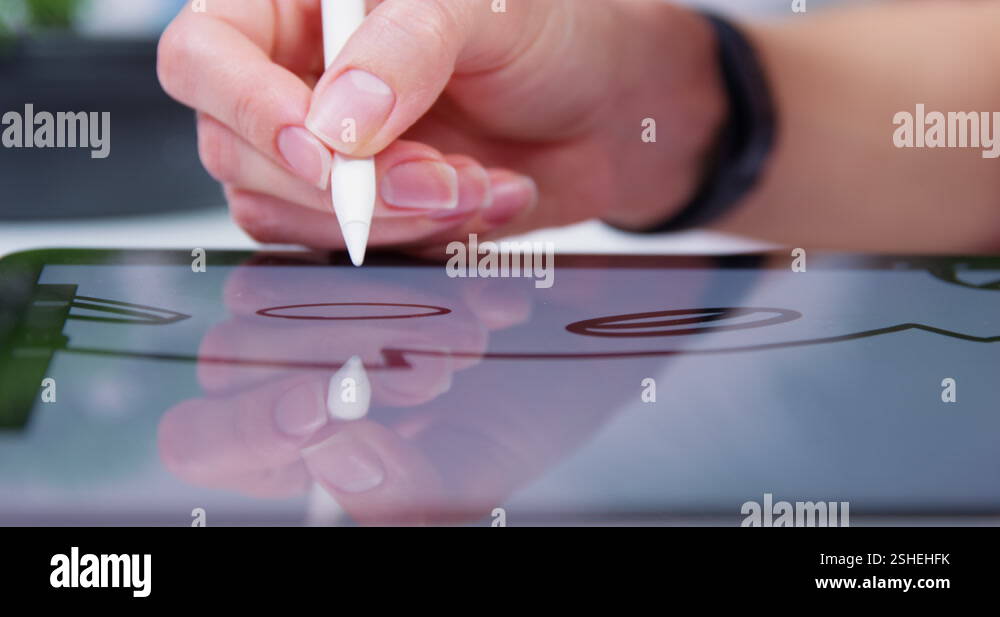 Artist draws lines using digital pencil and tablet, tapping on screen ...
