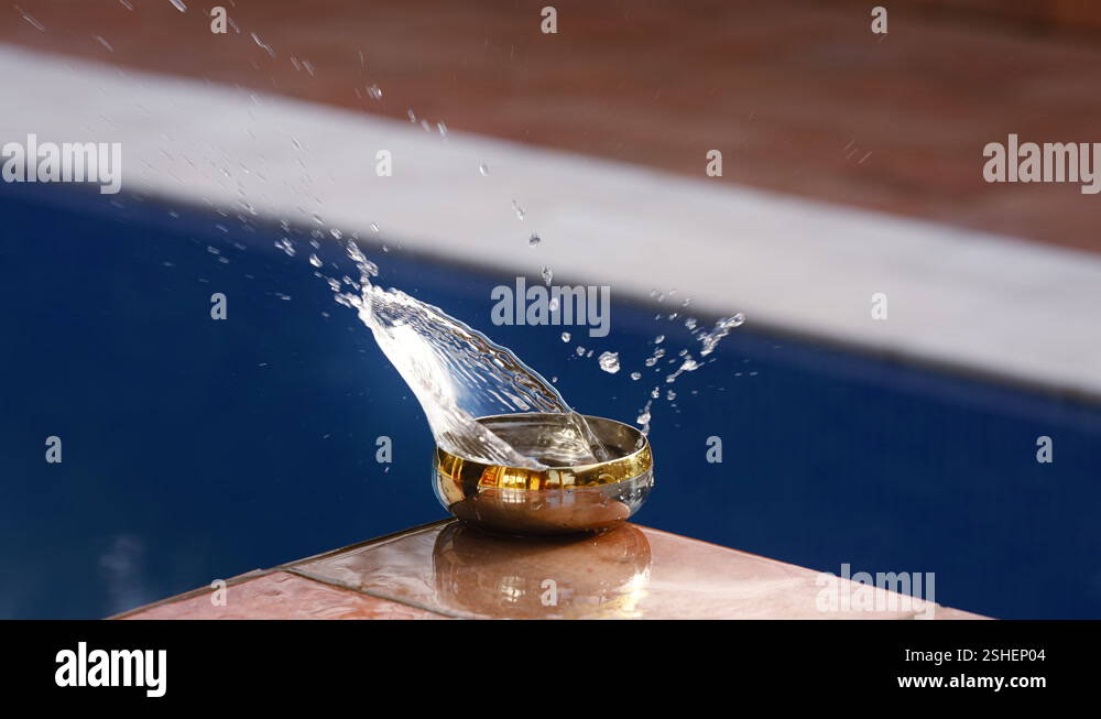 water splashing in a small bowel sending ripples outwards in a circular ...