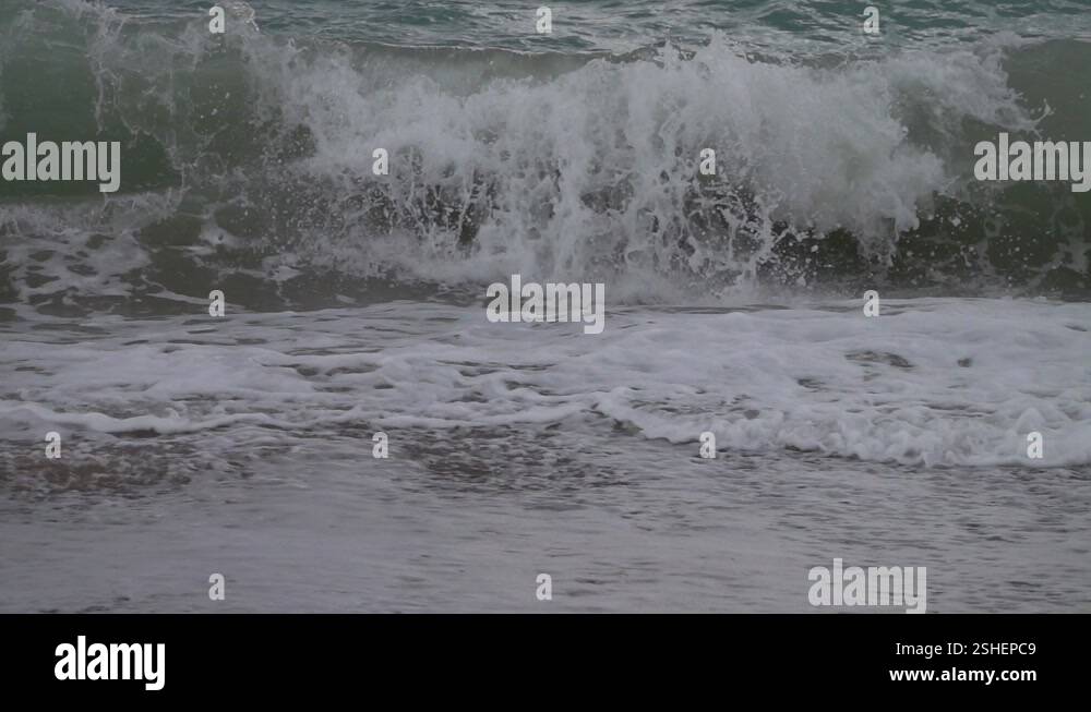 Extreme slow motion wave breaking against a sandy beach Stock Video ...