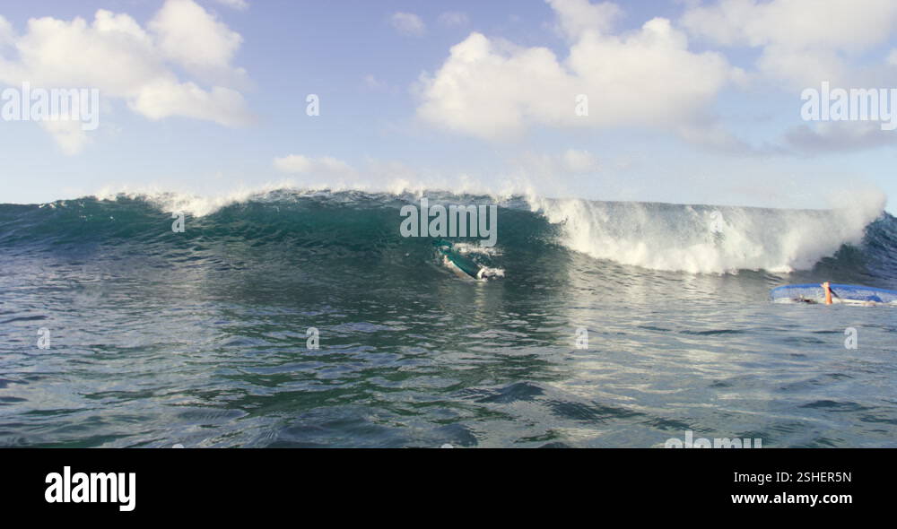 Slow Motion Panning A Woman Surfer As She Paddles And Falls Off A ...
