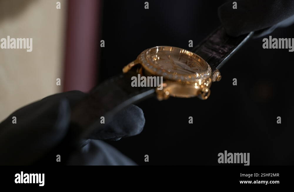 VERTICAL Horologist holding luxury gold and sparkling diamond Chopard Stock Video Footage - Alamy