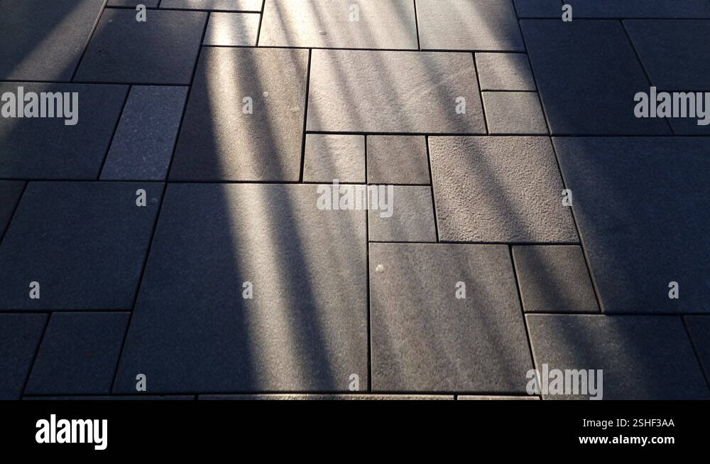 Sun rays on square tiles floor: light falling on the pavement ...
