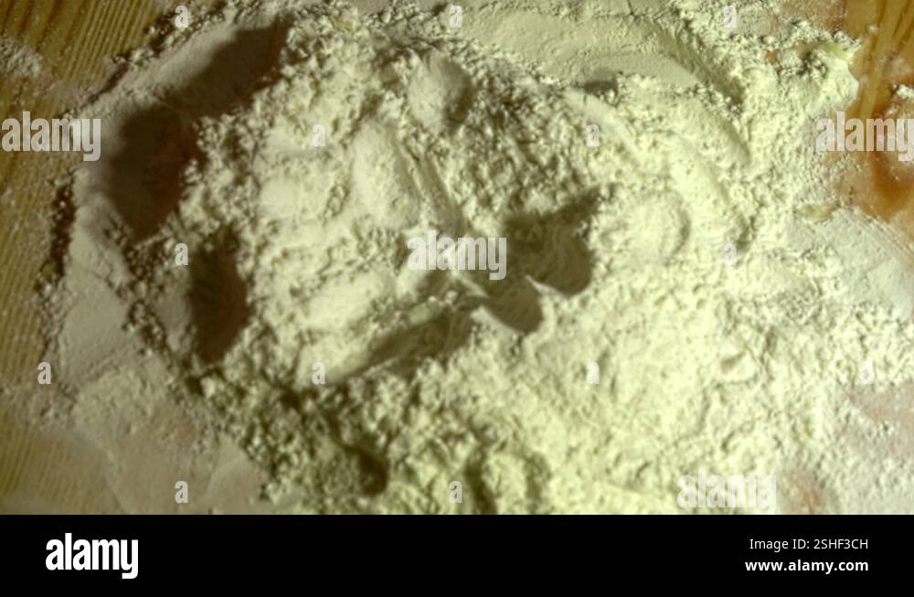 Dropping egg on flour, means for making cookies Stock Video Footage - Alamy