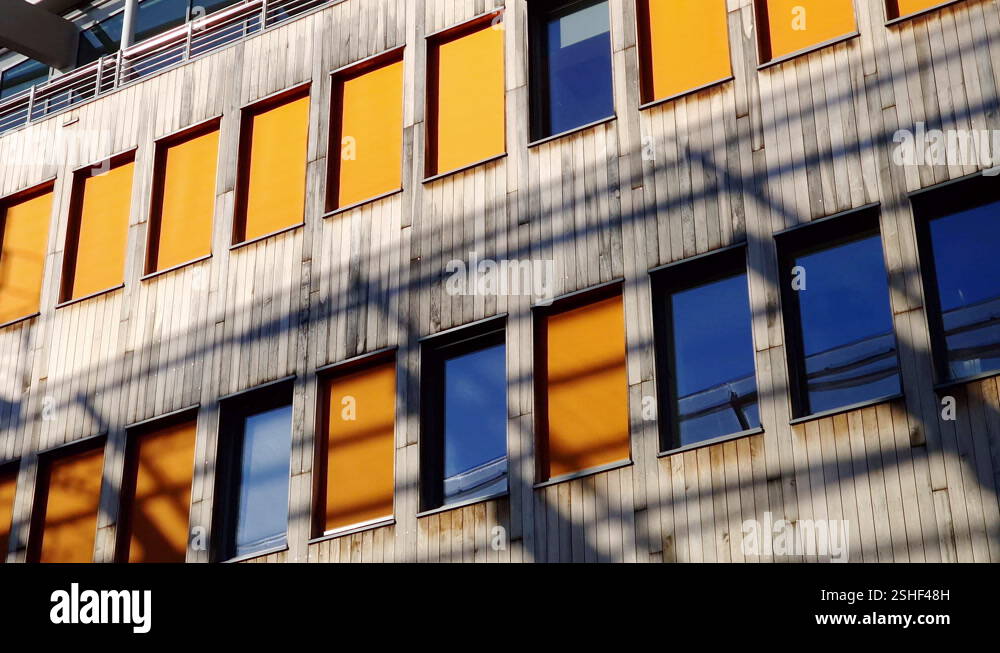 Orange window shades and timber cladding on the exterior wall, with ...