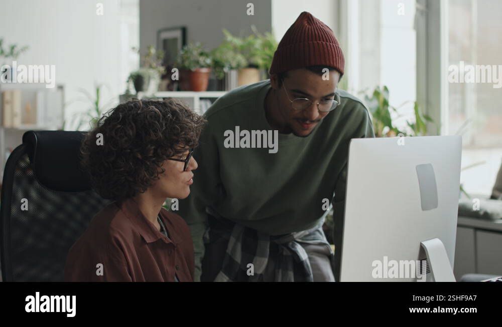 Colleagues Discussing Computer Program Stock Video Footage - Alamy