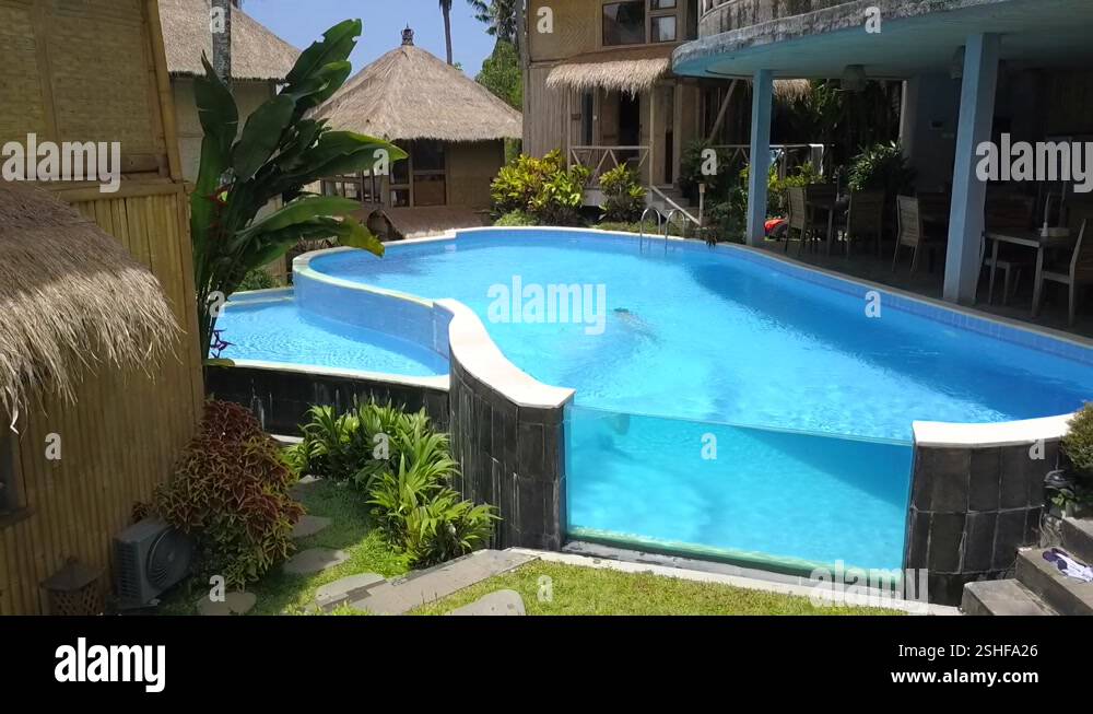 Girl head jump in swimming pool. Magic aerial view flight fly reverse Stock Video Footage - Alamy