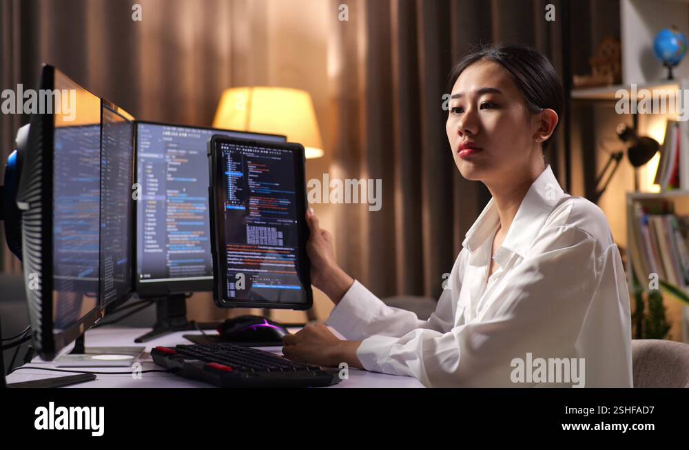 Asian Woman Programmer Looking At Database On Tablet While Creating ...