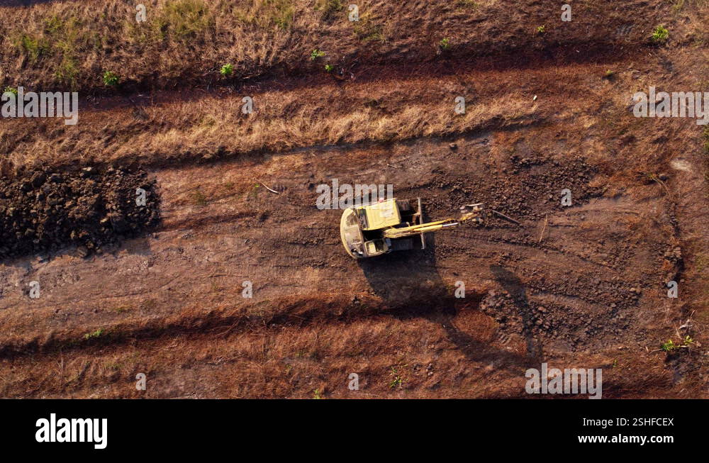 Excavator digging soil pits for the agricultural industry Stock Video ...